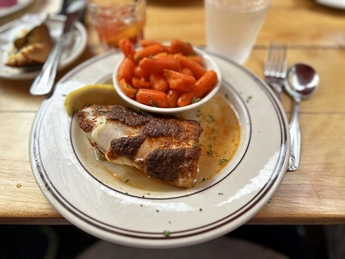 Blackened fish that's somehow both delicate and assertive, paired with glazed carrots bright enough to guide ships through harbor fog.
