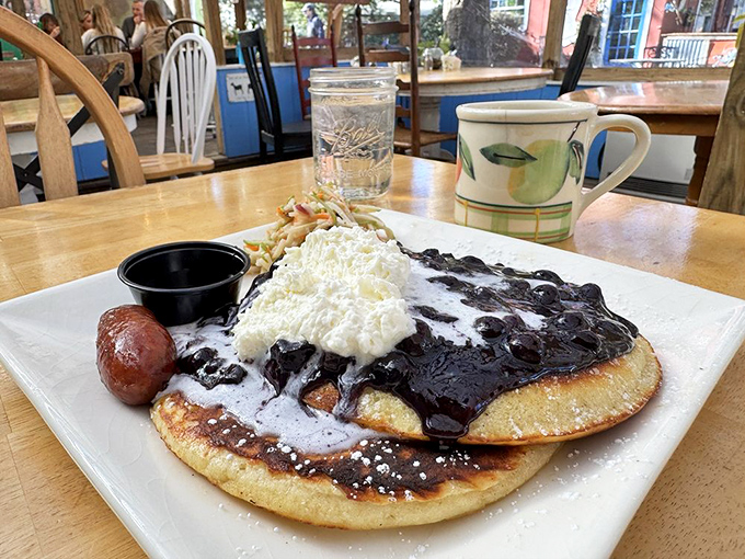 Blueberry pancakes swimming in syrup with a cloud of whipped cream&mdash;breakfast that makes you want to high-five the chef and hug your plate.