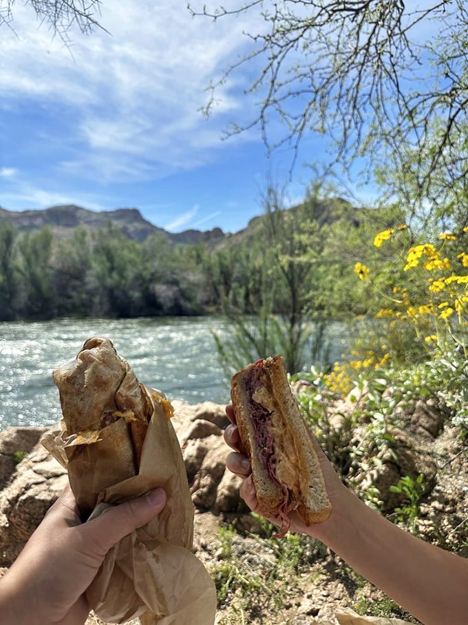 Nature provides the perfect backdrop for sandwich enjoyment. Some people climb mountains—others bring Reubens to them. Both are noble pursuits.