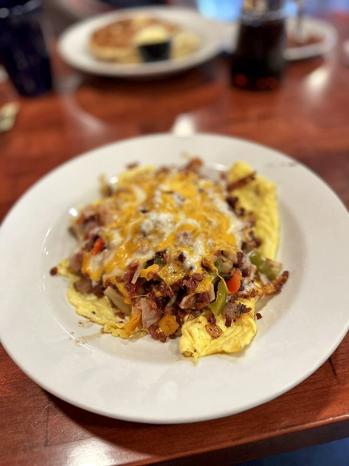 Breakfast that eats like a celebration. This omelet loaded with veggies and cheese proves morning meals deserve more than cold cereal's sad mediocrity. 
