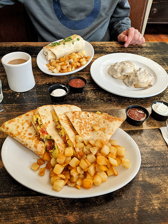 Breakfast burritos and biscuits with gravy sharing a plate like the breakfast power couple they are. Home fries playing matchmaker.