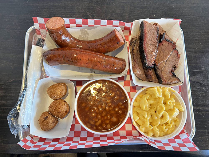 A meat lover's dream team: smoked sausage and brisket share the stage with baked beans and mac and cheese in perfect harmony.