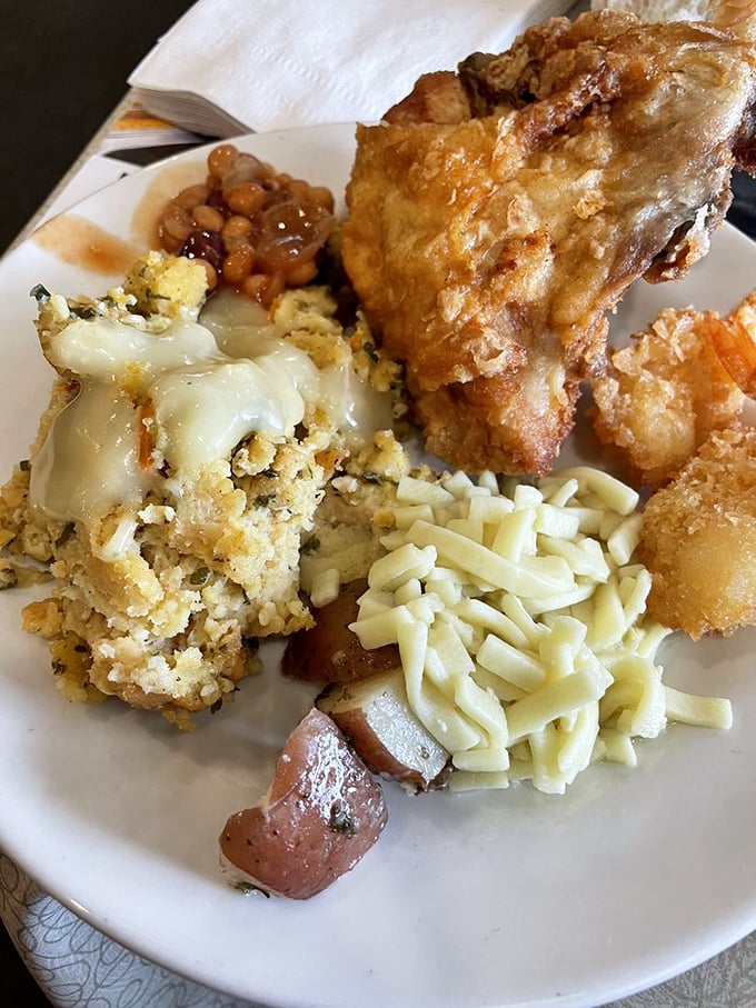 The holy trinity of comfort food: golden broasted chicken, buttery noodles, and stuffing that could make a vegetarian reconsider their life choices.