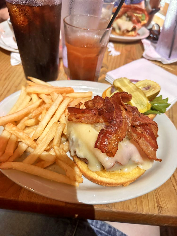 The bacon practically waves hello! This beauty showcases why The Vortex's reputation is built on burgers that require both hands and a strategy.