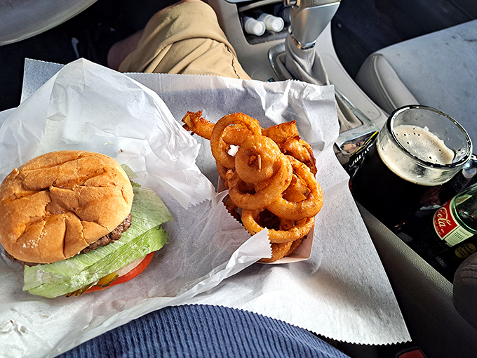 The holy trinity of drive-in dining: a perfectly dressed burger, golden onion rings, and that signature root beer&mdash;all enjoyed from the comfort of your car's captain's chair.