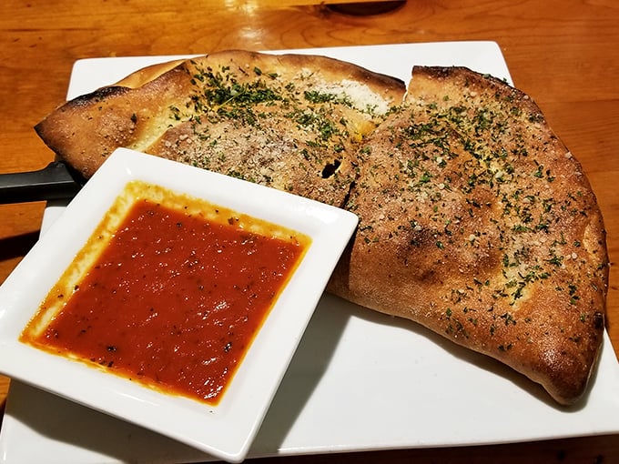Herb-dusted calzone with marinara for dipping&mdash;the kind of handheld Italian treasure that makes you forget pizza ever existed.