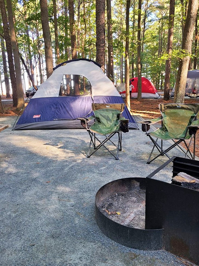 The quintessential camping setup: tent, chairs, fire pit, and absolutely no deadline to meet except sunset.