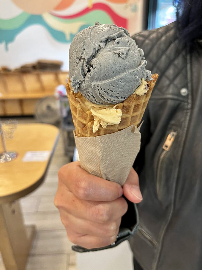 A study in contrasts: charcoal-dark ice cream meets golden waffle cone. Like a delicious science experiment you can eat.