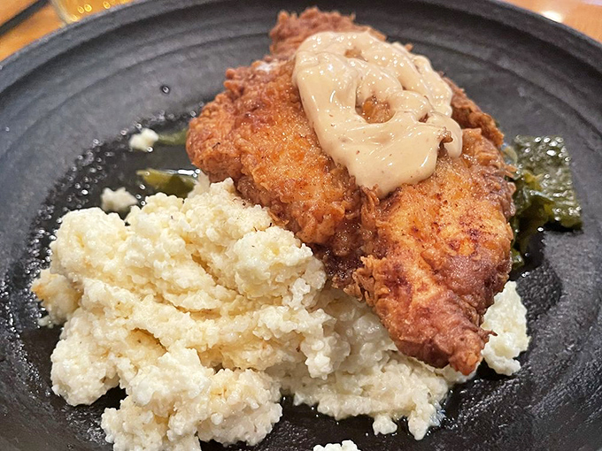 Southern comfort meets Delaware refinement. This crispy masterpiece resting on creamy grits is what comfort food dreams are made of.