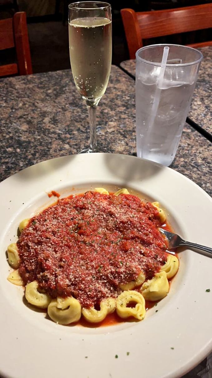 The holy trinity of Italian dining: perfectly cooked pasta, hearty meat sauce, and a glass of wine. Add bread and you've got heaven on earth.
