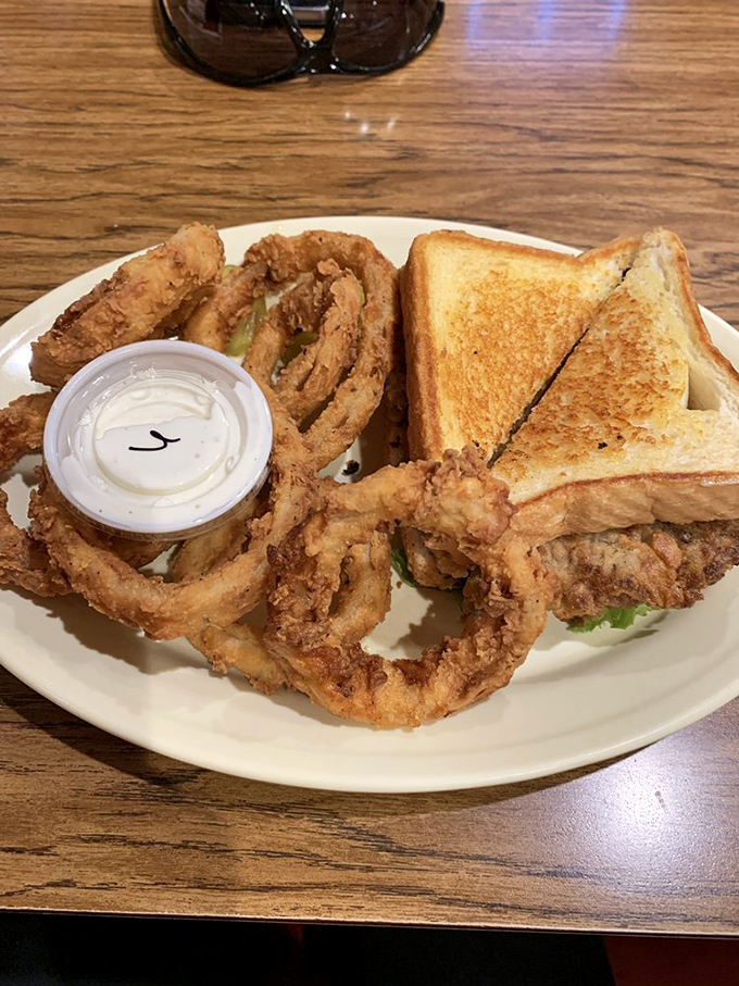 This chicken-fried steak sandwich defies conventional sandwich physics – how do you contain such crispy, gravy-soaked magnificence between mere bread?