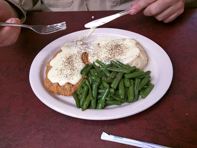 Chicken fried steak smothered in gravy, sitting beside those legendary mashed potatoes. This plate has comforted more souls than a Sunday sermon.