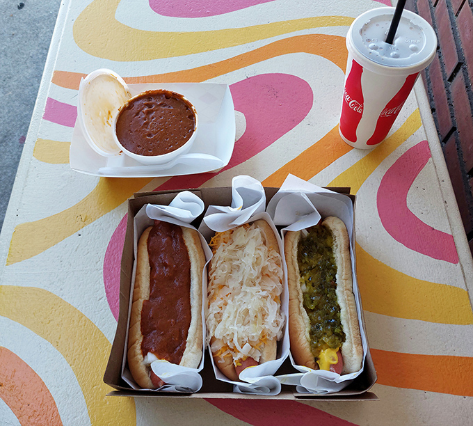 A trifecta of temptation! From classic chili to sauerkraut-topped delights, this spread is the United Nations of hot dog diplomacy.