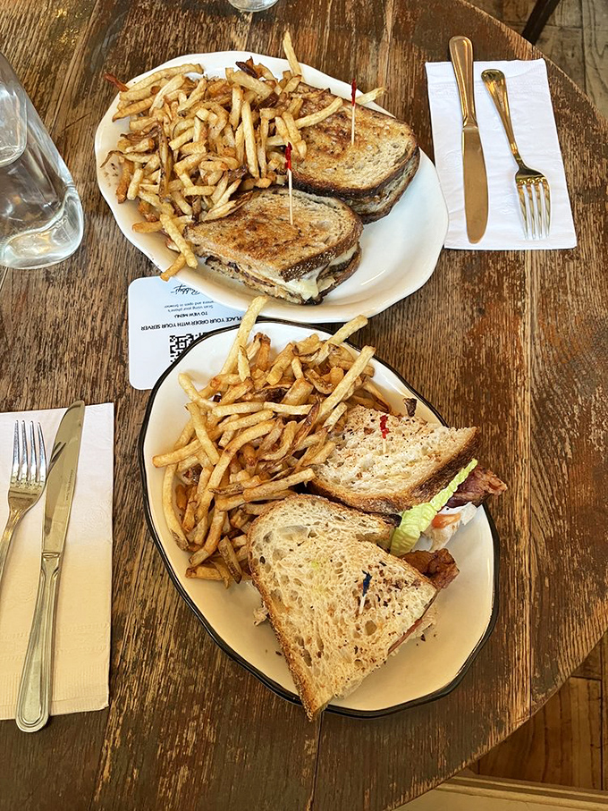 The sandwich that launched a thousand food comas: crispy fries alongside golden-toasted bread stuffed with layers of deliciousness that defy gravity.
