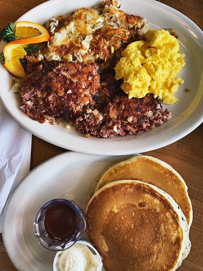 Morning glory on a plate: corned beef hash with scrambled sunshine and pancakes so perfectly golden they deserve their own California zip code.