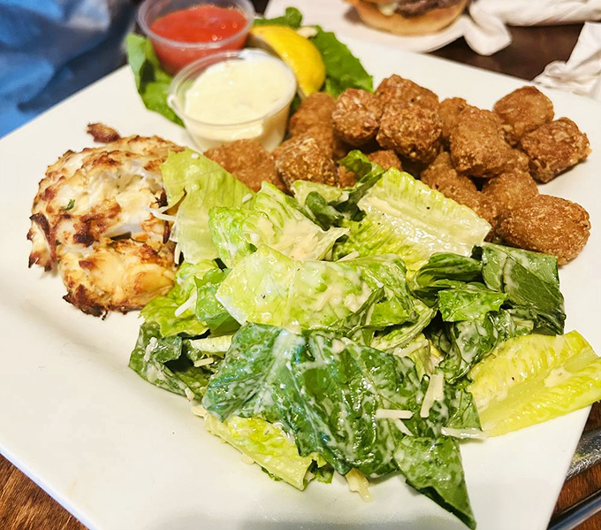 A crab cake, crisp salad, and hush puppies create the holy trinity of coastal comfort food&mdash;a plate that makes you feel like you've finally arrived at vacation.