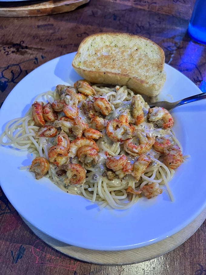 Crawfish pasta that proves Arkansas understands Cajun cooking &ndash; plump tails nestled in creamy sauce over perfectly cooked spaghetti with garlic bread standing by.