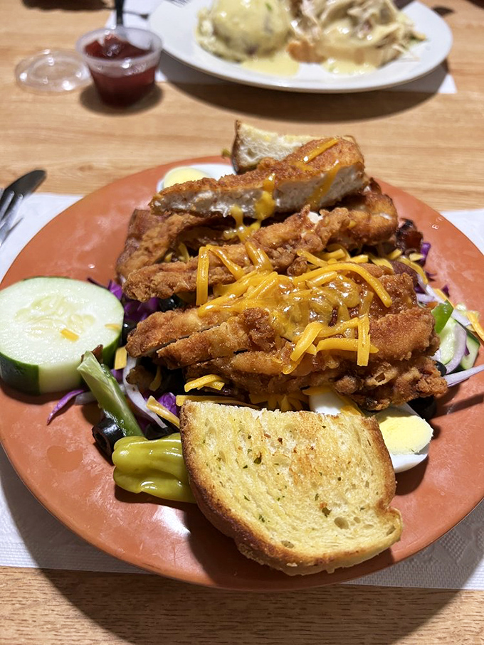 Crispy chicken strips lounging on a colorful salad bed&mdash;proof that "eating healthy" and "eating happy" don't have to be mutually exclusive concepts.