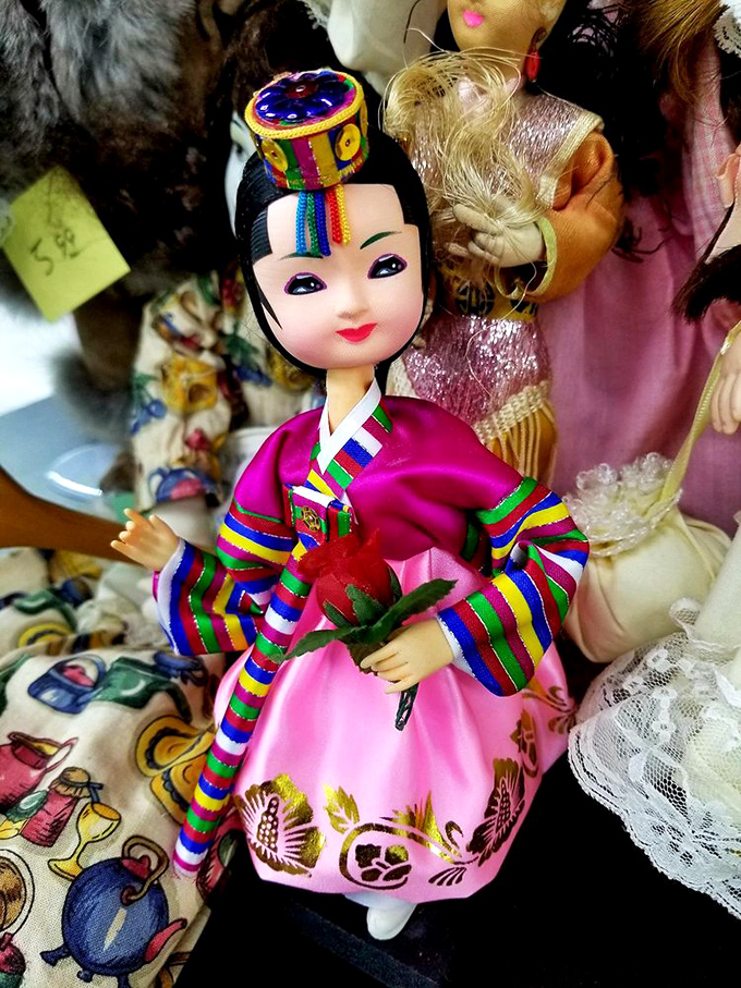 This traditional Korean doll's vibrant hanbok showcases exquisite craftsmanship, bringing international flair to the eclectic treasure trove of cultural collectibles.