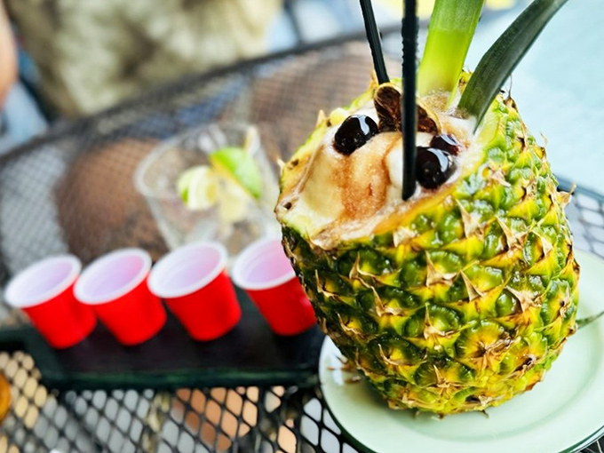 A pineapple transformed into tropical cocktail magic. Those little red cups in the background suggest this isn't the only fun happening at this table.