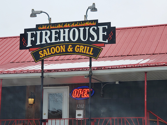 The Firehouse Saloon & Grill sign glows like a beacon for the hungry. When those flames light up at night, resistance is futile.