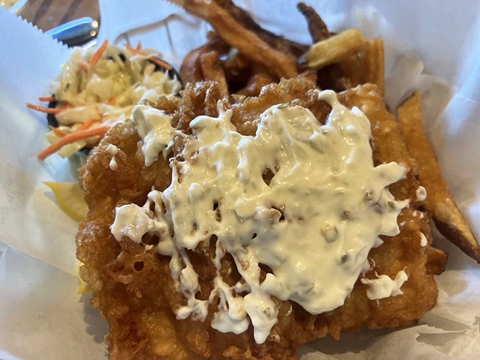 Fish and chips that would make a Dubliner homesick. The golden batter shatters with each bite, revealing flaky white fish beneath.
