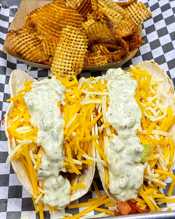 Seafood tacos done right—tender fish nestled in tortillas with vibrant toppings and a creamy sauce that ties everything together beautifully.