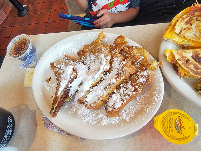 French toast dusted with powdered sugar like the first snow of winter&mdash;except this snowfall tastes like cinnamon dreams.
