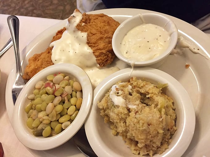 A holy triumvirate: fried chicken under a blanket of gravy, mac and cheese that's practically a religion, and lima beans to keep your doctor remotely satisfied.