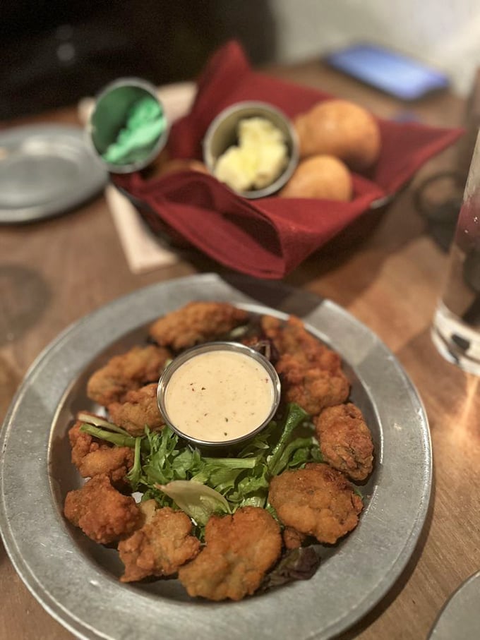 These aren't just fried oysters—they're edible pearls of the Delaware coast, crispy-coated and arranged like a delicious necklace around creamy dipping sauce.