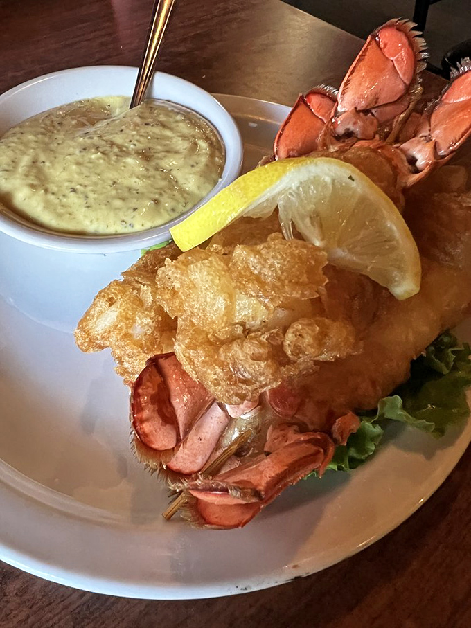 Lobster tails that look like they're dressed for a fancy party, but taste like they're giving you a warm hug. The accompanying sauce is mandatory, not optional.