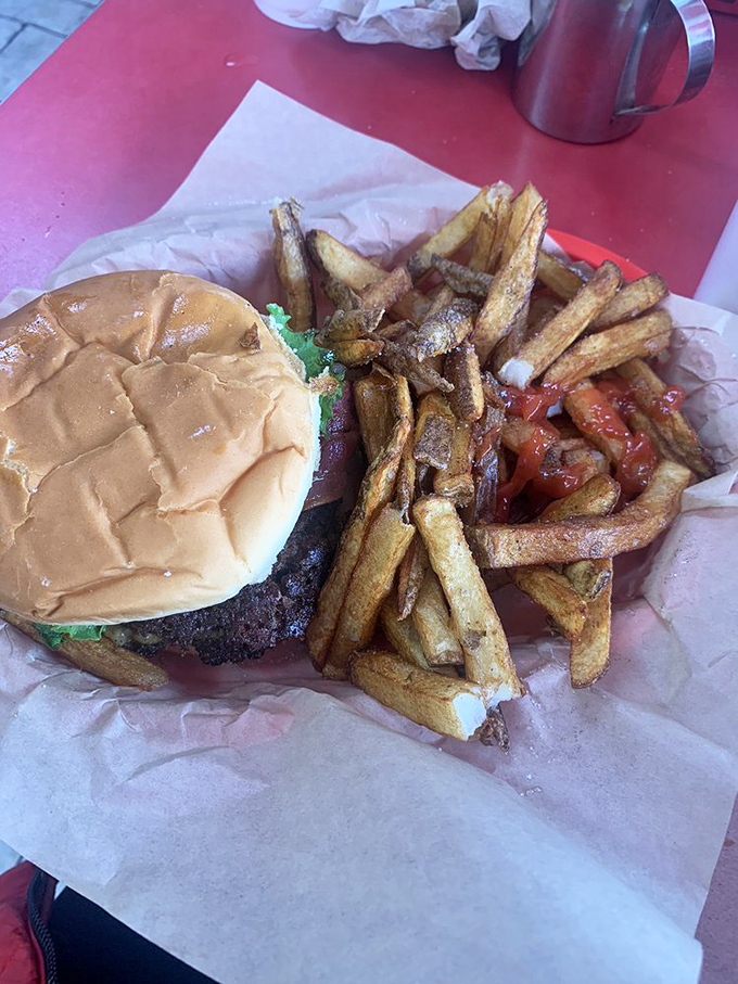 The perfect American tableau: golden fries with that ideal exterior crunch, a substantial burger, and the promise of napkin-requiring satisfaction.