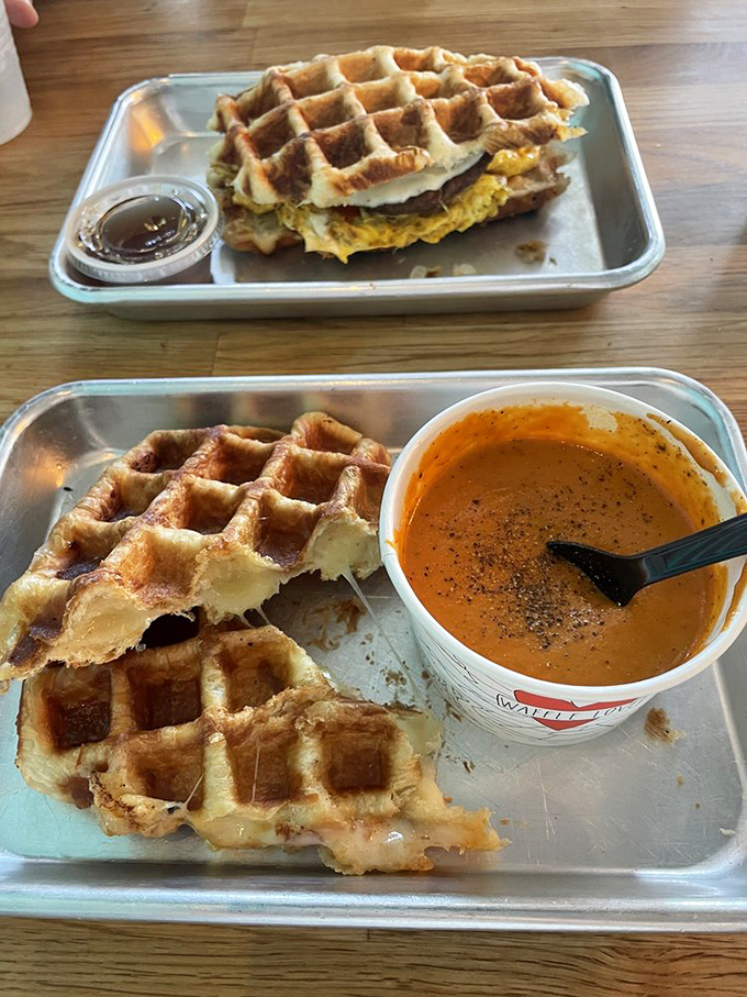 Whoever decided to put grilled cheese between waffles deserves a Nobel Prize in comfort food. The tomato bisque sidekick seals the deal.