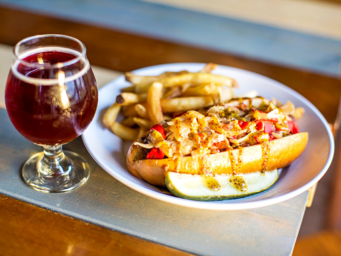 When a hot dog evolves from ballpark necessity to culinary statement &ndash; complete with gourmet toppings and that ruby beer companion.
