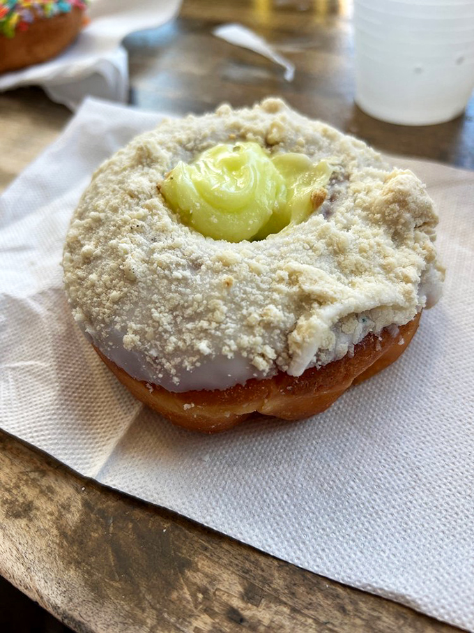 Key lime filling peeks out like buried treasure. The graham cracker crumbs aren't just garnish&mdash;they're the perfect textural counterpoint to that tangy, creamy center.