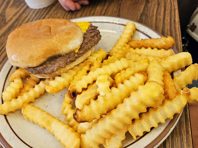 The lunch shift brings its A-game with this classic burger alongside perfectly golden crinkle-cut fries that shatter with each bite.