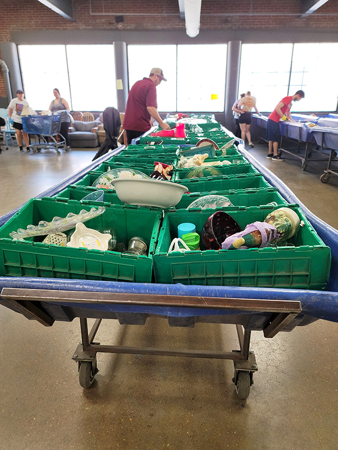 Green sorting bins filled with glassware and kitchen treasures &ndash; somewhere in there might be the serving dish your grandmother once owned.