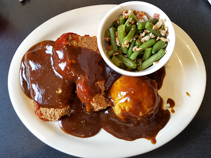 The meatloaf plate whispers "take a nap after lunch" with its smothered gravy, green beans, and portions that could feed a small Midwestern town.
