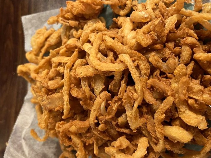 Onion rings so crispy they deserve their own fan club. These golden halos aren't just a side dish—they're a religious experience for the taste buds.