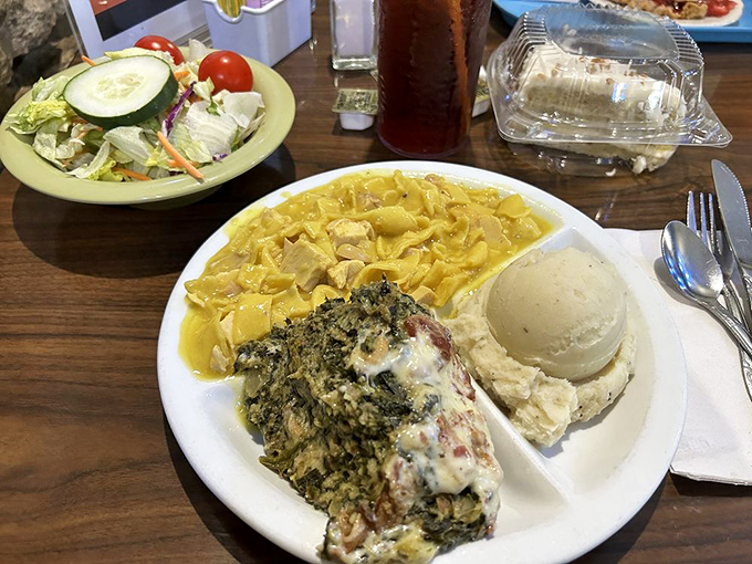 A plate where spinach and pasta find harmony under melted cheese, proving that vegetables can indeed be friends with carbs.
