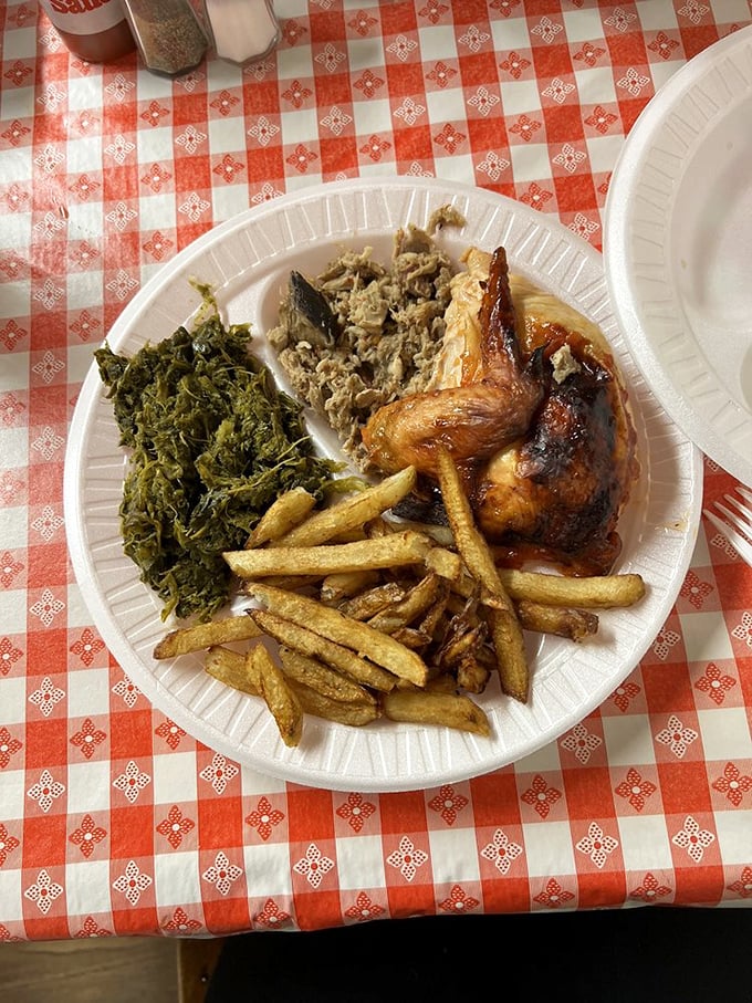 The classic trifecta: smoky pulled pork, garden-fresh collards, and golden-brown chicken&mdash;a plate that tells North Carolina's culinary story better than any book.