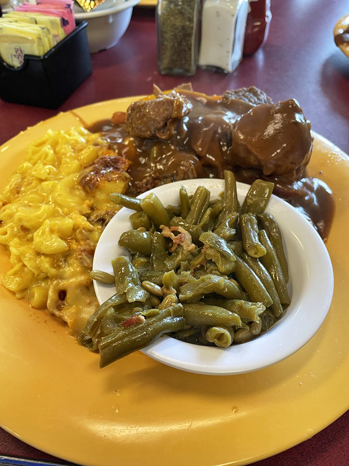 Pot roast so tender it practically surrenders to your fork, accompanied by mac and cheese and green beans that actually taste like vegetables.