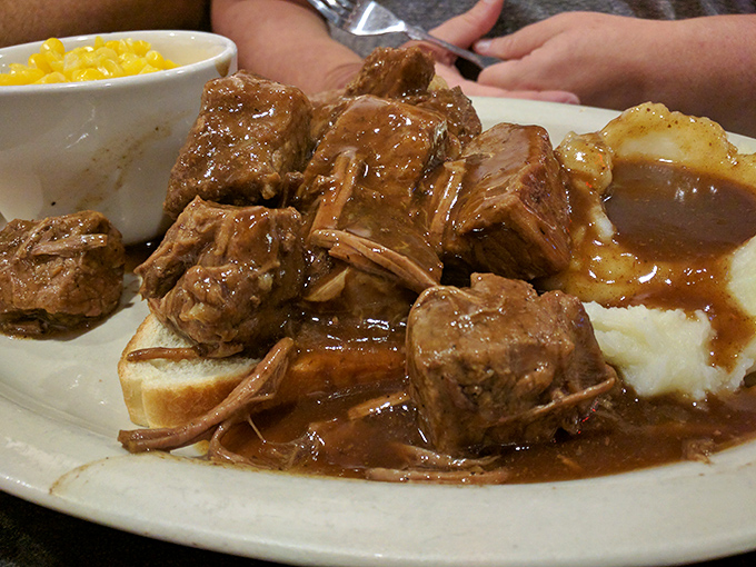Pot roast so tender it practically surrenders to your fork, swimming in gravy that's clearly been simmering since yesterday.