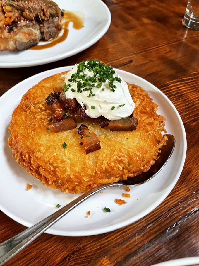 Potatoes Minneapolis—a golden disc of potato perfection topped with bacon and cream. Carbohydrates have never looked so noble or necessary.