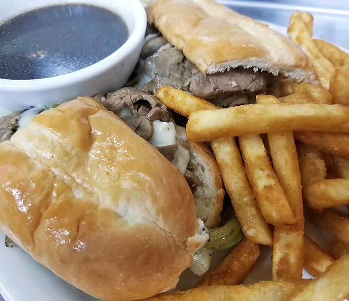 The French dip's cooler cousin—tender prime rib stuffed into a golden roll with a side of savory jus for dunking.