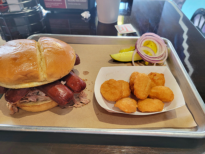 A sandwich that requires both hands and several napkins. The marriage of sausage and pulled pork proves that some unions are truly blessed.