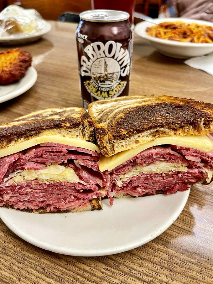 This isn't just a sandwich; it's a skyscraper of corned beef and sauerkraut that demands both hands and a strategy.