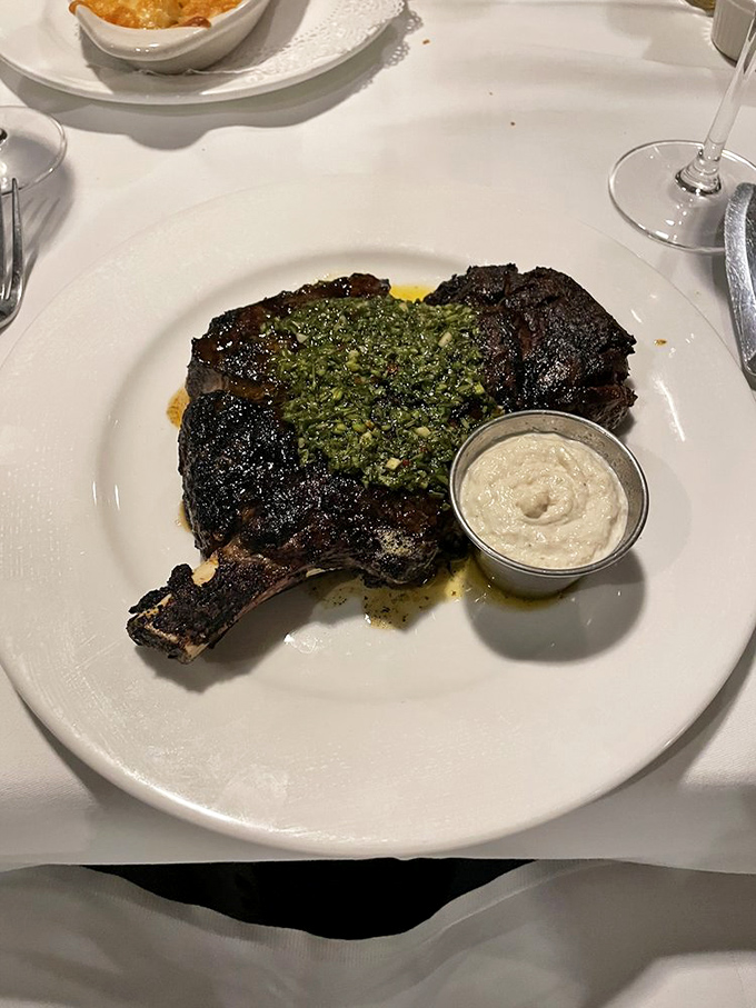 Perfect grill marks on this ribeye are like nature's GPS coordinates to Flavor Town. The horseradish sauce stands by, ready for duty. 