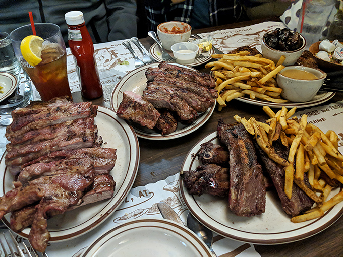 A table that tells the whole story: multiple plates, multiple meats, and the collective joy of people who know they've made an excellent life decision.