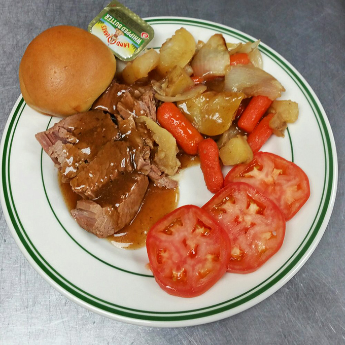 Sunday dinner on a plate: tender roast beef swimming in rich gravy alongside garden-fresh vegetables and sliced tomatoes that taste like summer.